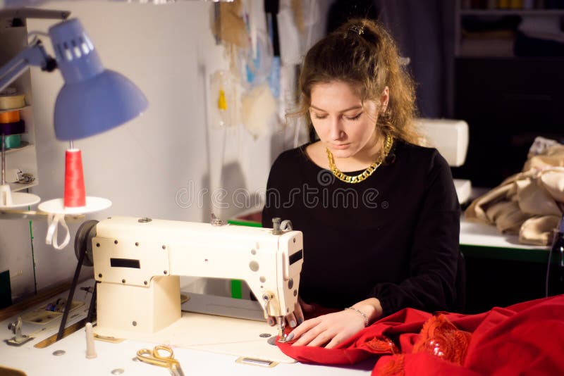 Dressmaker Working on the Sewing Machine. Tailor Making a Garment ...