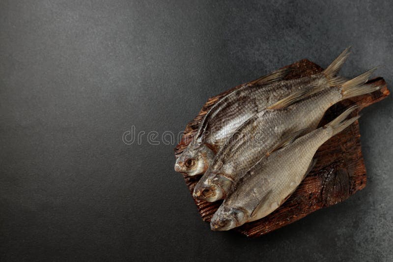 Dried Bream Fish on a Cutting Board on a Black Background Stock Image ...