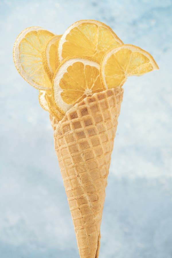 Dried Citrus Fruit Slices in a Waffle Ice Cream Cone Over Blue Stock ...