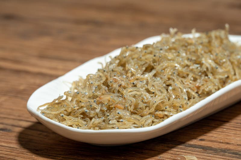 The Dried Clove Fish in the Container is on the Wood Grain Table Stock ...