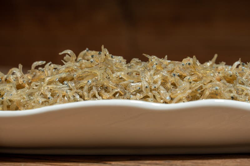 The Dried Clove Fish in the Container is on the Wood Grain Table Stock ...