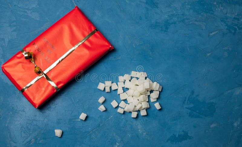 Dried Coconut Cubes with Gift Box on a Blue Background Stock Photo ...