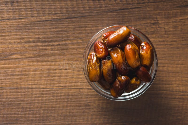 Dried Dates Fruit in Bowl on Wooden Table. Top View Stock Photo - Image ...