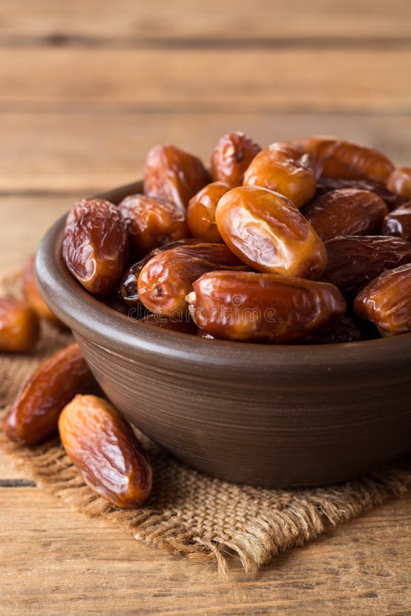 Dried Dates Fruit in Ceramic Bowl on Wooden Table. Stock Image - Image ...