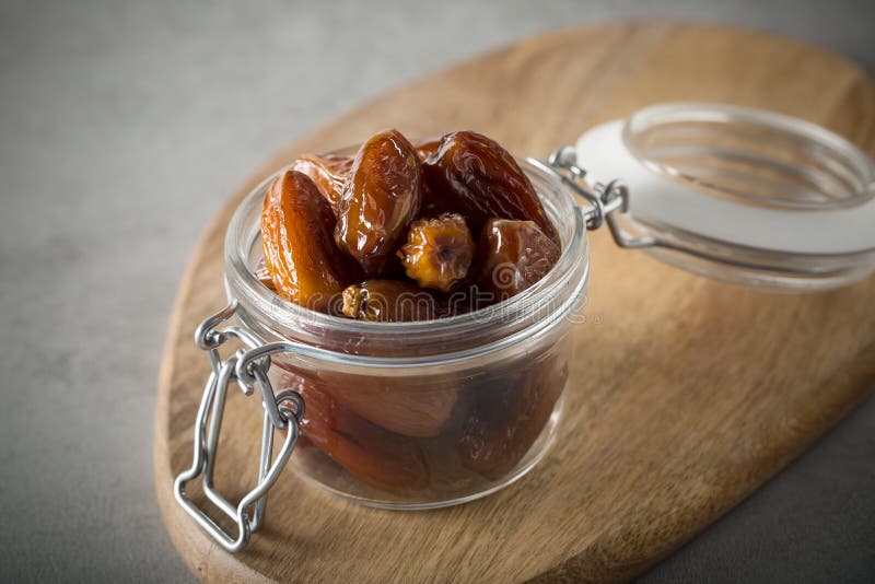 Dried Dates in a Glass Jar on a Light Grey Marble Table Stock Image ...