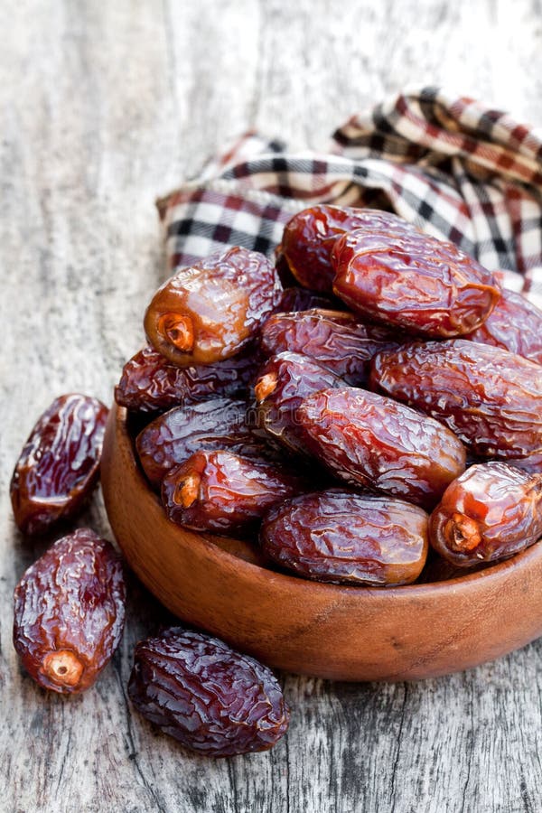 Dried Dates in Wooden Bowl on Rustic Table Stock Image - Image of ...