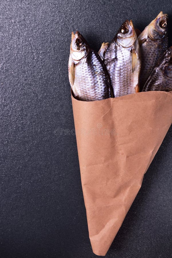 Dried Fish In A Bag With Paper On A Black Surface Stock Image - Image ...