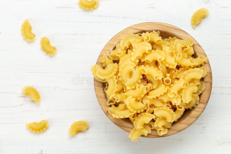 Dried Macaroni Cockerel Scallops. Pasta in a Wooden Bowl and on a White ...