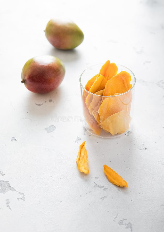 Dried Mango Slices with Two Fresh Raw Mangoes Stock Photo - Image of ...