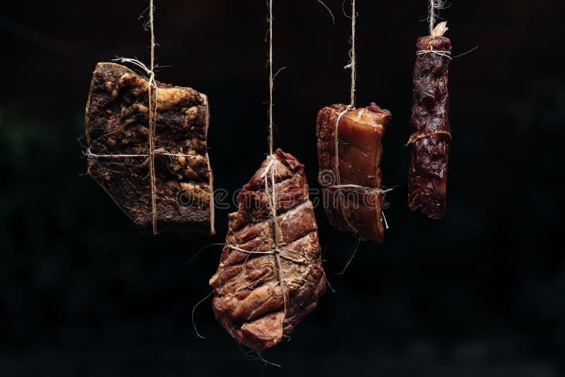 Dried Meat Hanging by a Thread on a Black Background Stock Photo ...