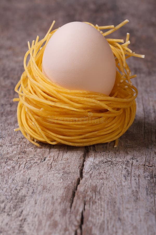 Dried Pasta Nest with Chicken Eggs Vertical Stock Photo - Image of ...