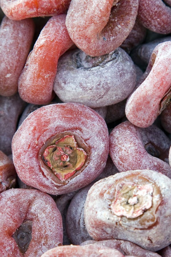Dried Persimmon with Powdered Sugar Lies on a Stone Dish, on a Dark ...