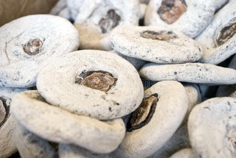 Dried Persimmon with Powdered Sugar Lies on a Stone Dish, on a Dark ...