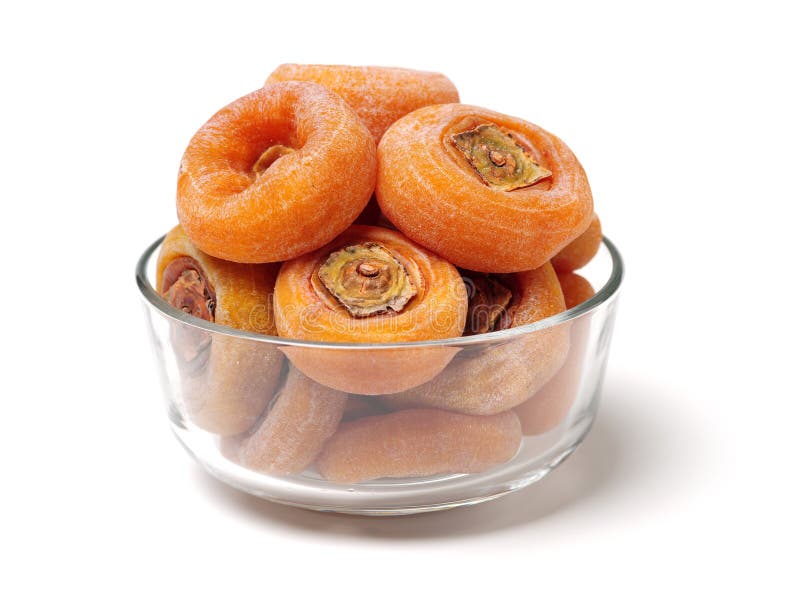 Dried Persimmon with Powdered Sugar Lies on a Stone Dish, on a Dark ...