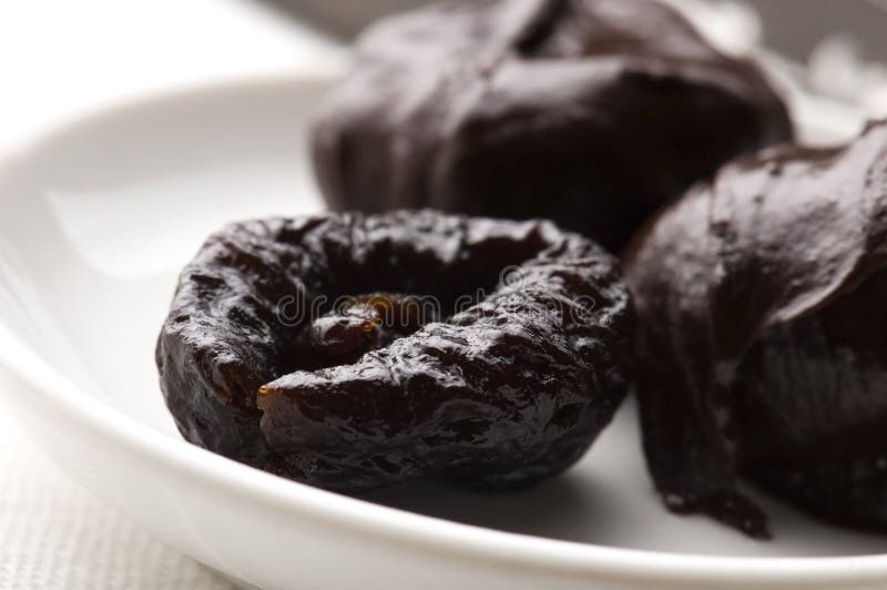 Dried plums in chocolate stock image. Image of black - 22607927