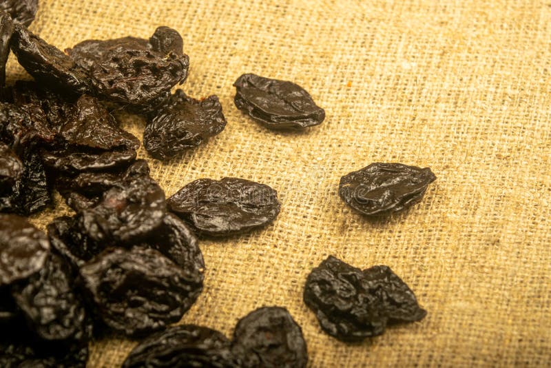 Dried Prunes in Bulk on Burlap with a Rough Texture. Close Up Stock ... Dried Prunes in Bulk on Burlap with a Rough Texture. Close Up Stock ...