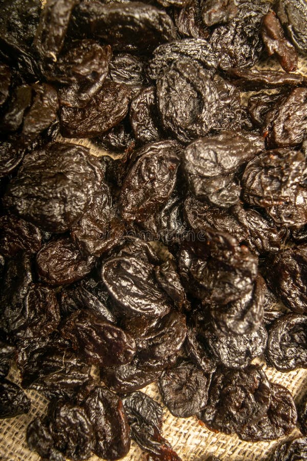 Dried Prunes in Bulk on Burlap with a Rough Texture. Close Up Stock ... Dried Prunes in Bulk on Burlap with a Rough Texture. Close Up Stock ...