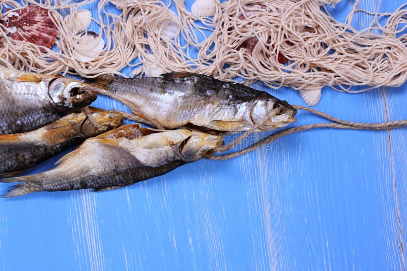 Dried Rudd Fish and Fishing Net on Blue Background Stock Image - Image ...