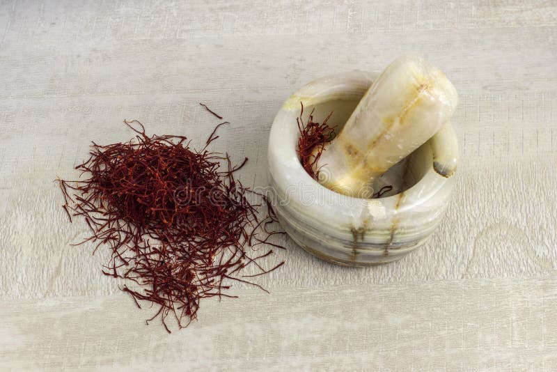 Dried Saffron Threads and a Marble Mortar on the White Wooden Table ...