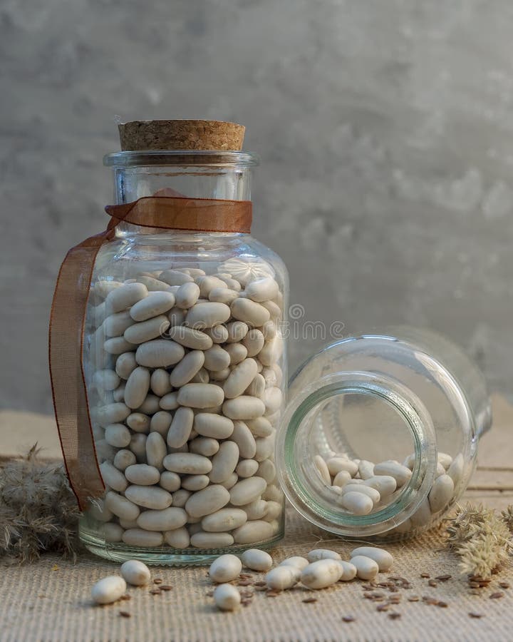 Dried White Beans in Two Glass Containers, One of Which is Open ...