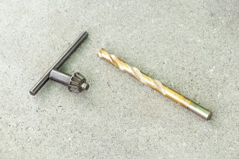Drill and Chuck Key Lie on Concrete Surface Stock Photo - Image of ...