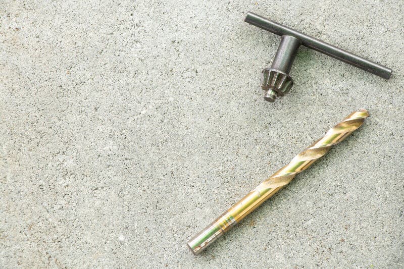 Drill and Chuck Key Lie on Concrete Surface Stock Image - Image of ...