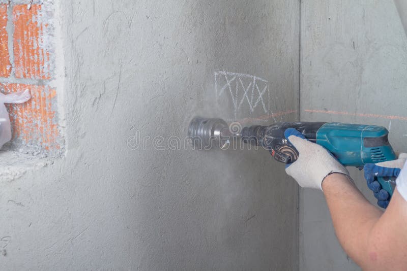 Drill a Hole in the Wall with a Puncher for a Box for Mounting an ...