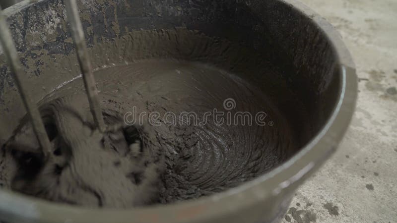 The Drill Nozzle is Inserted into Wet Cement. Wet Mortar Mixture for ...