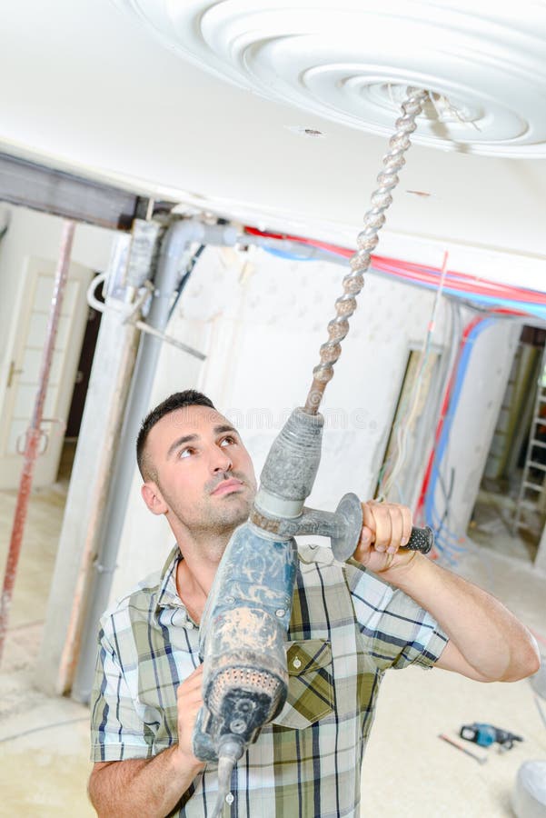 Drilling into the ceiling stock photo. Image of installation - 266081750