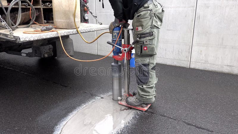 Drilling a Hole through the Asphalt Surface of a Road with a Core ...