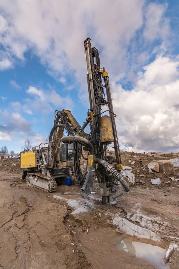 Drilling Machine in a Construction Site Surrounded by Rock and Mud ...