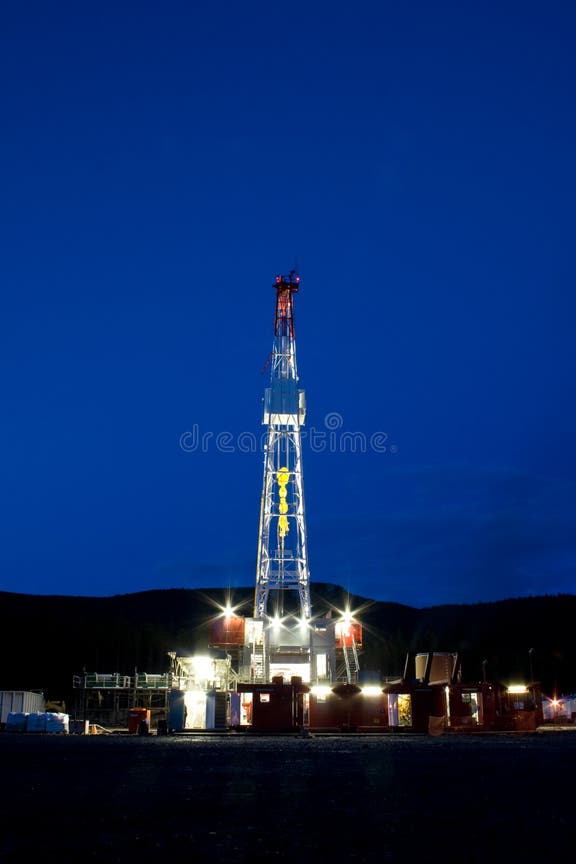 Drilling rig at night stock image. Image of compressor - 5921701