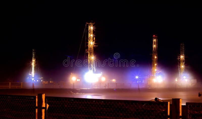 Oil Rigs at night. stock photo. Image of industry, engineering - 23034472