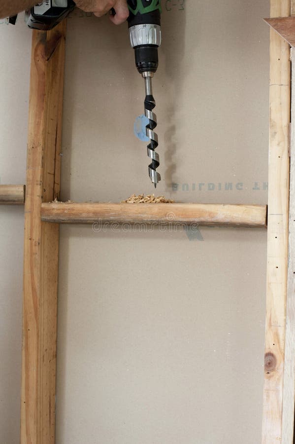 Drilling hole in stud wall stock image. Image of wooden - 251007843