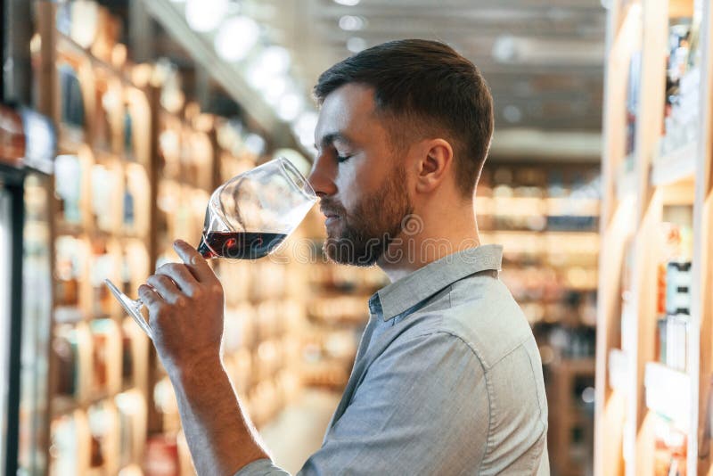 Drink Tasting. Man is Choosing Wine in the Store Stock Image - Image of ...