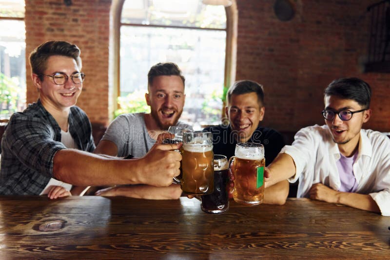 Drinking Beer. People in Casual Clothes Sitting in the Pub Stock Photo ...