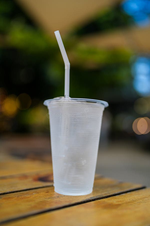 Drinking Cool Water in a Plastic Cup with a White Straw Stock Photo ...
