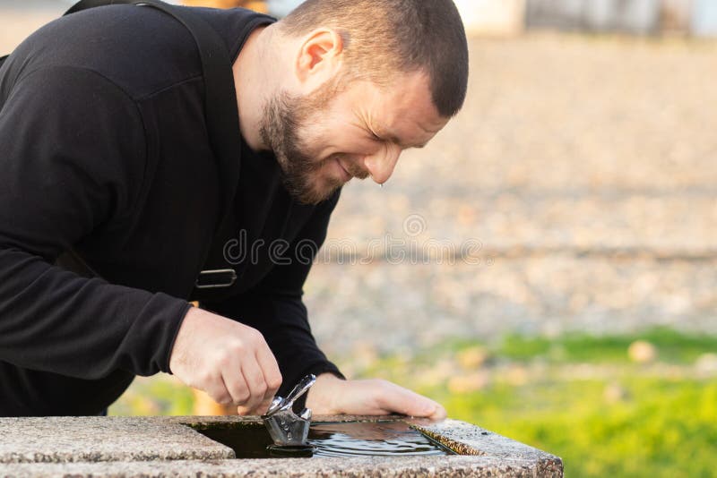 Drinking Fountain, a Man Splashed His Face in the Park with Water from ...