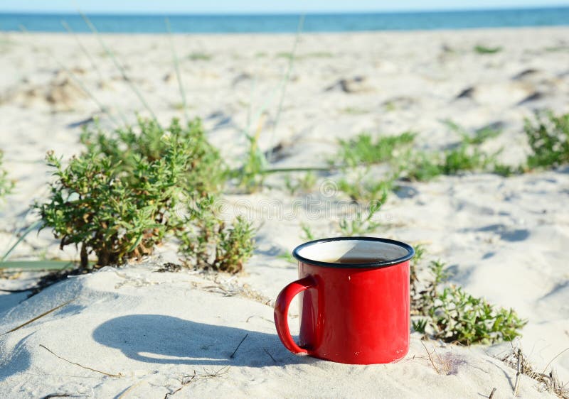 Drinking Tea, Coffee from a Red Metal Cup on a Wild Sandy Beach at the ...