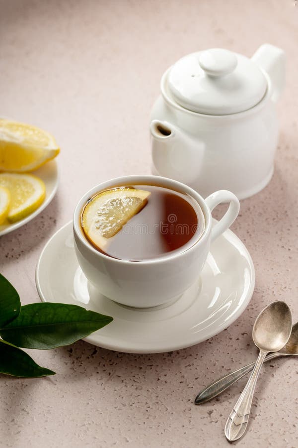Drinking Tea, White Ceramic Cup and Tea Pot with Black Tea and Lemon ...