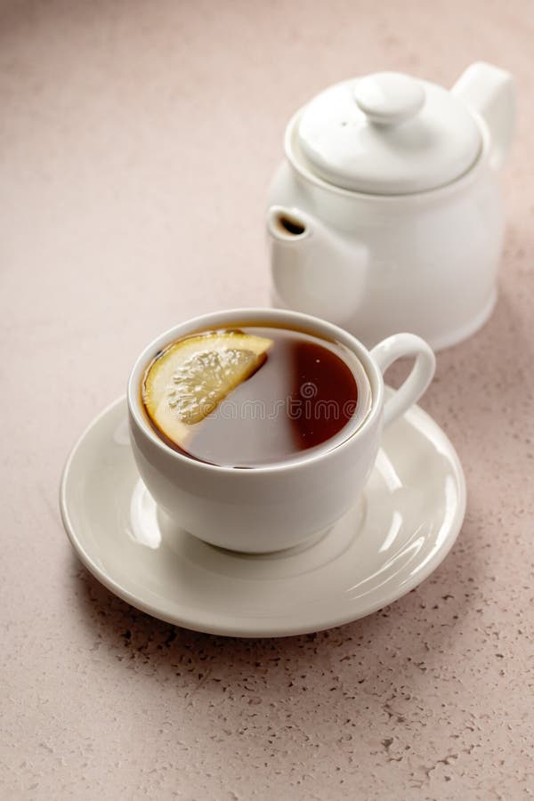 Drinking Tea, White Ceramic Cup and Tea Pot with Black Tea and Lemon ...