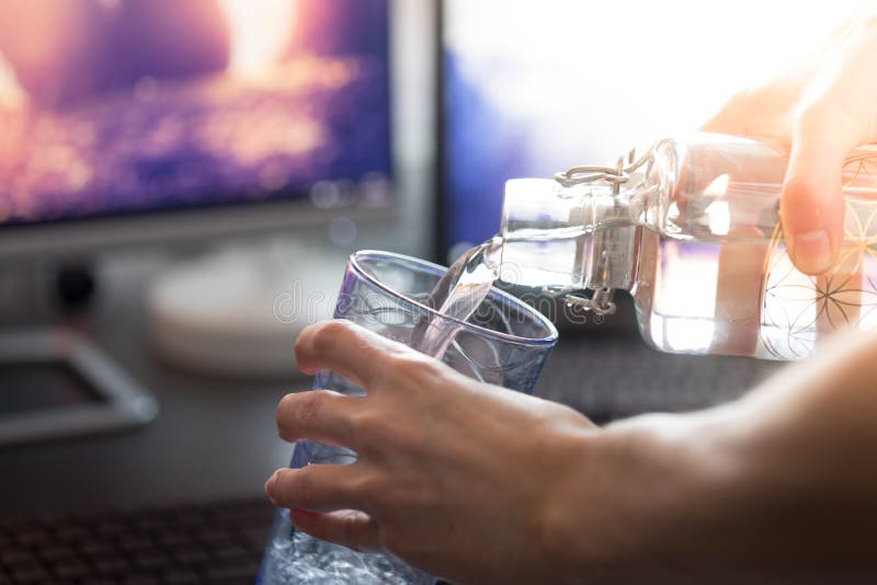 Drinking Water in the Office: Close Up of Glass Bottle, Workplace Stock ...