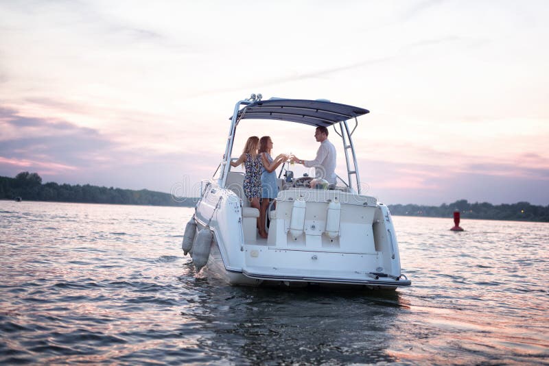 Drinks on a boat in sunset stock photo. Image of moment - 146547324