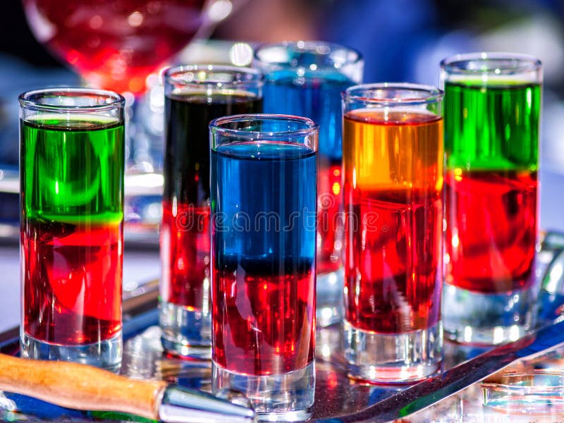 Drinks of Different Density and Different Colors are Poured into Glass ...