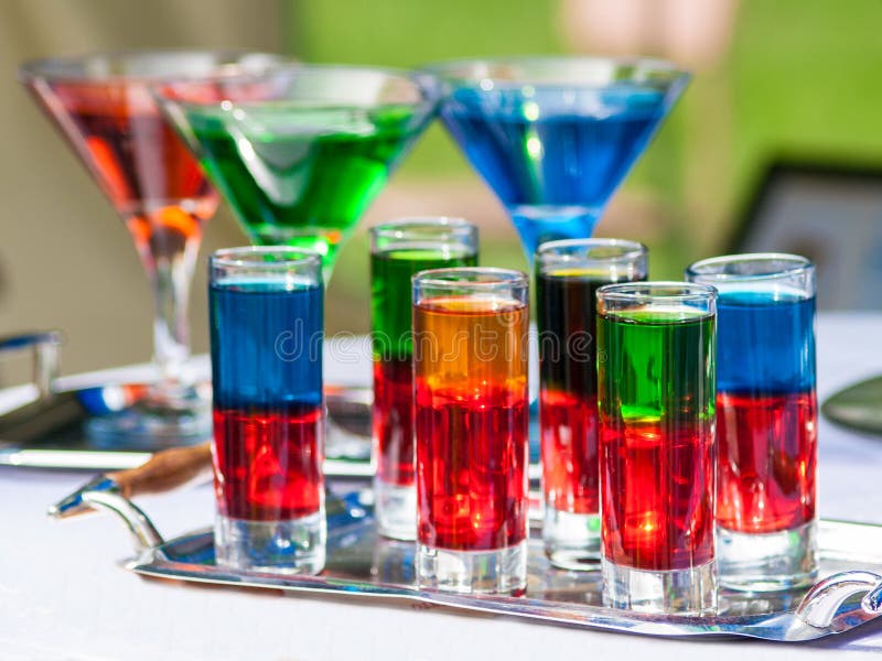 Drinks of Different Density and Different Colors are Poured into Glass ...