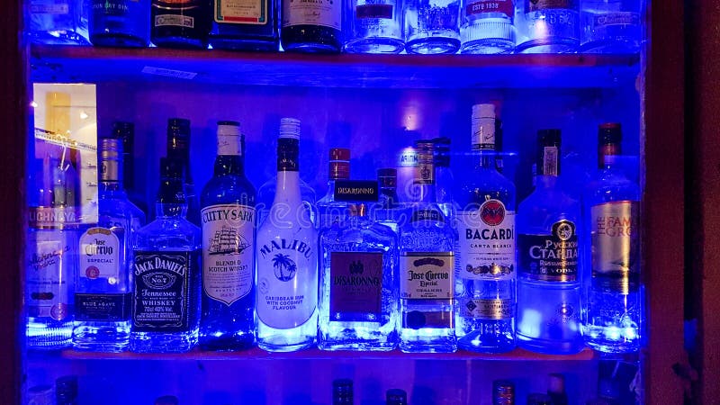 Drinks on the Shelf on a Night Bar in Greece with Blue and Red Lights ...