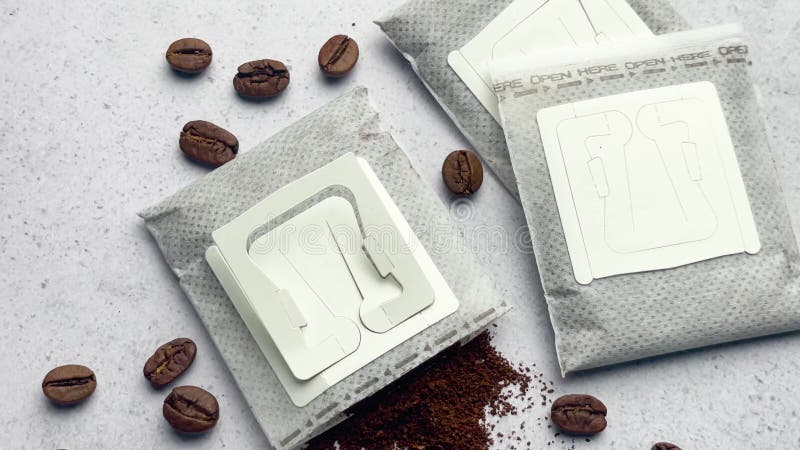 Drip Coffee Paper Bags with Coffee Beans on a Grey Concrete Stock Video ...