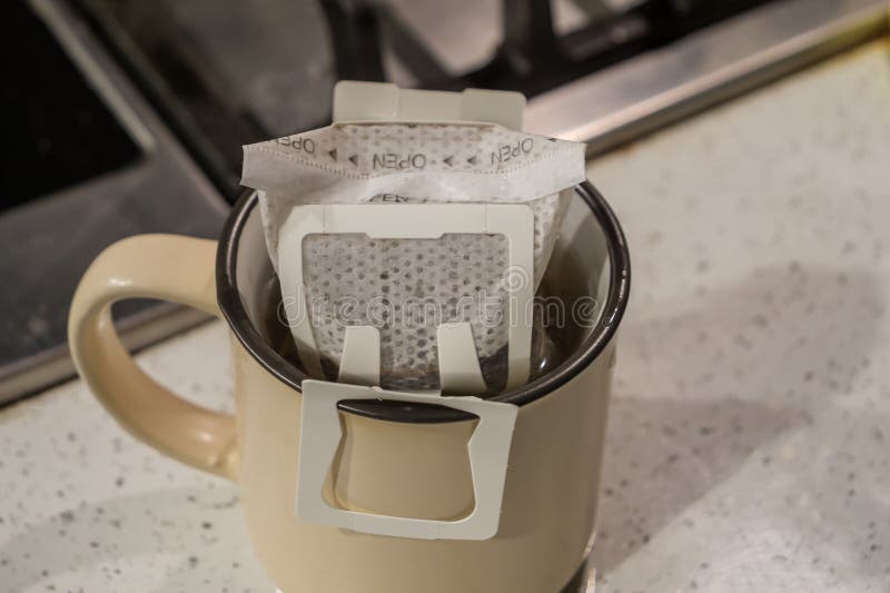 Drip Filter Coffee Bag in Cup on Kitchen Counter Stock Photo - Image of ...