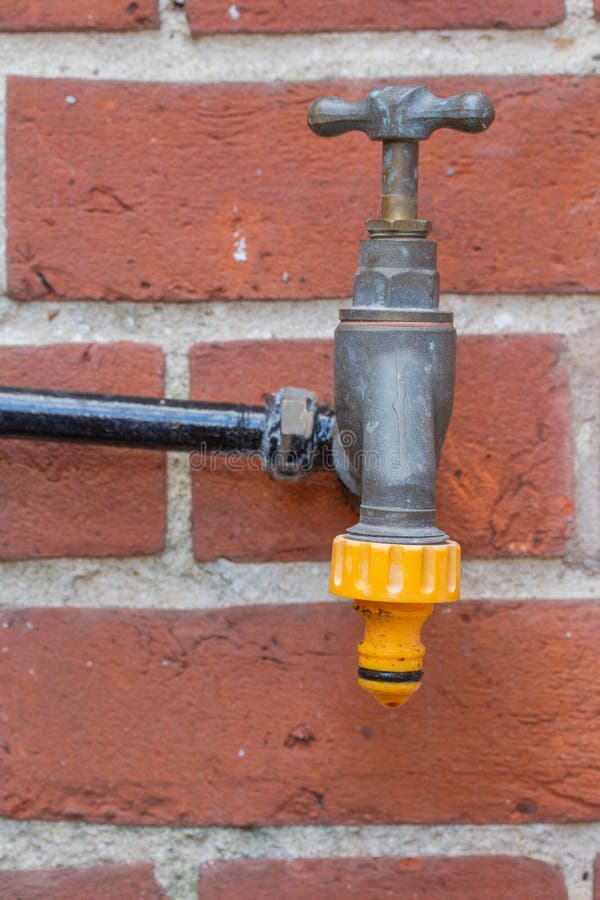 Dripping Garden Tap Mounted on a Brick Wall Stock Photo - Image of ...