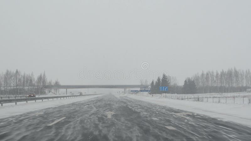 Front Window Point of View Driving through Snowy Forest Road during ...
